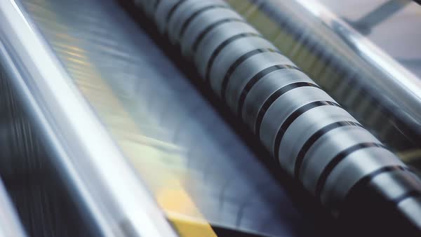 Plastic sheet travel through industry machine. Static shot of the ...