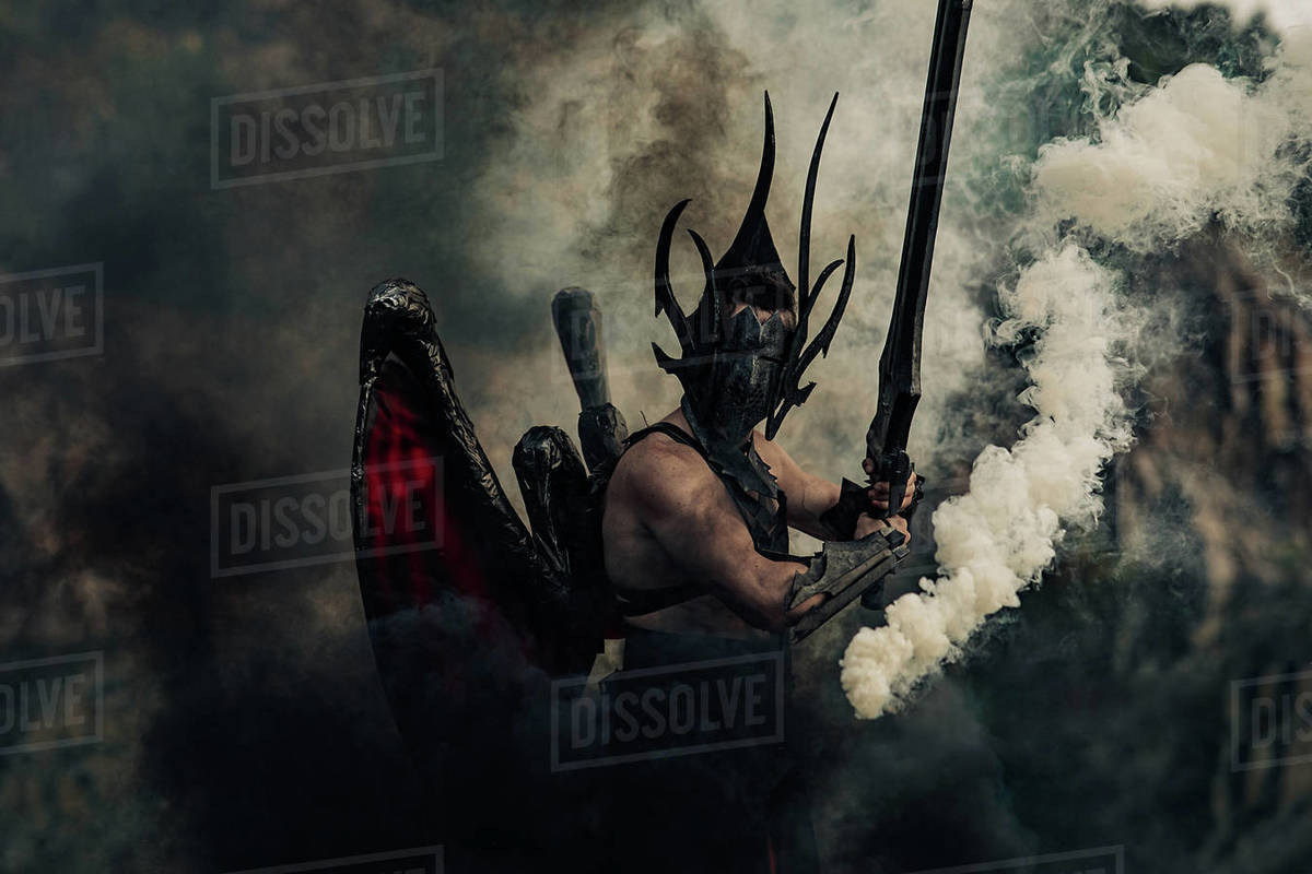 Man in image of daemon of death with wings behind his back stands with ...