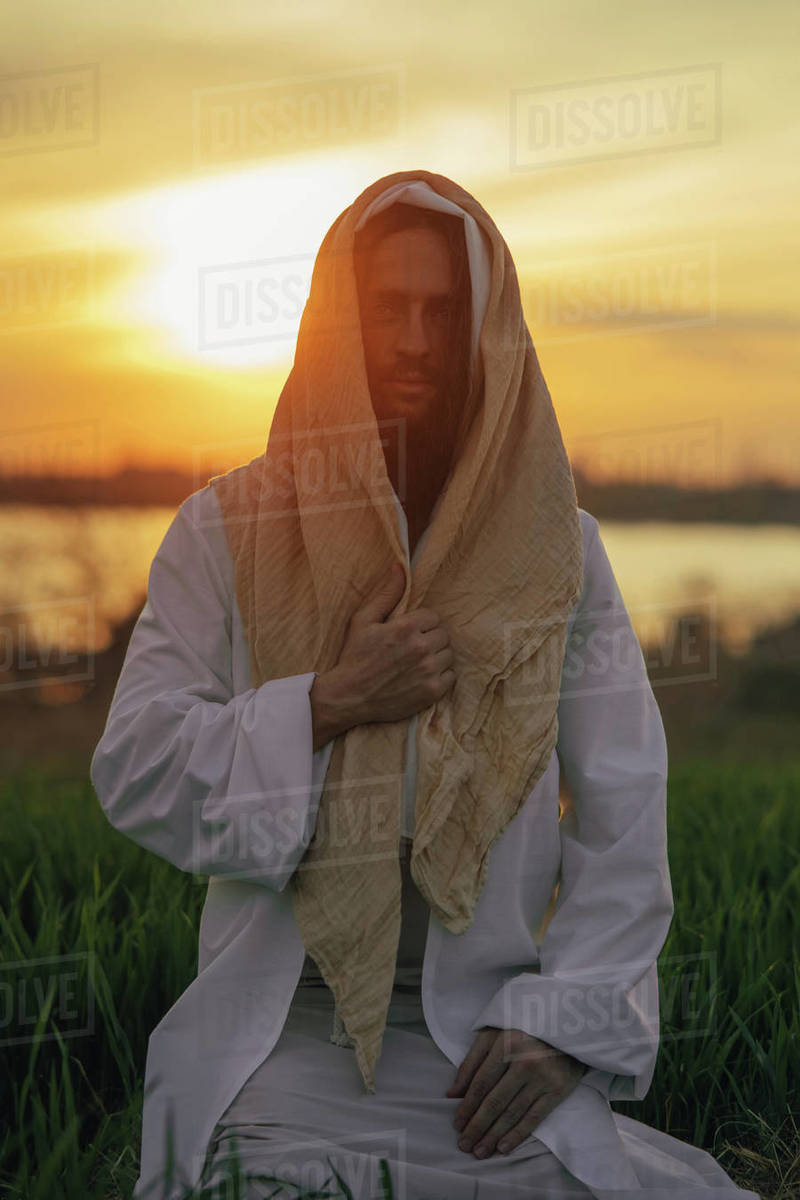 Prophet sits in meadow clothed in his traditional white robe against ...