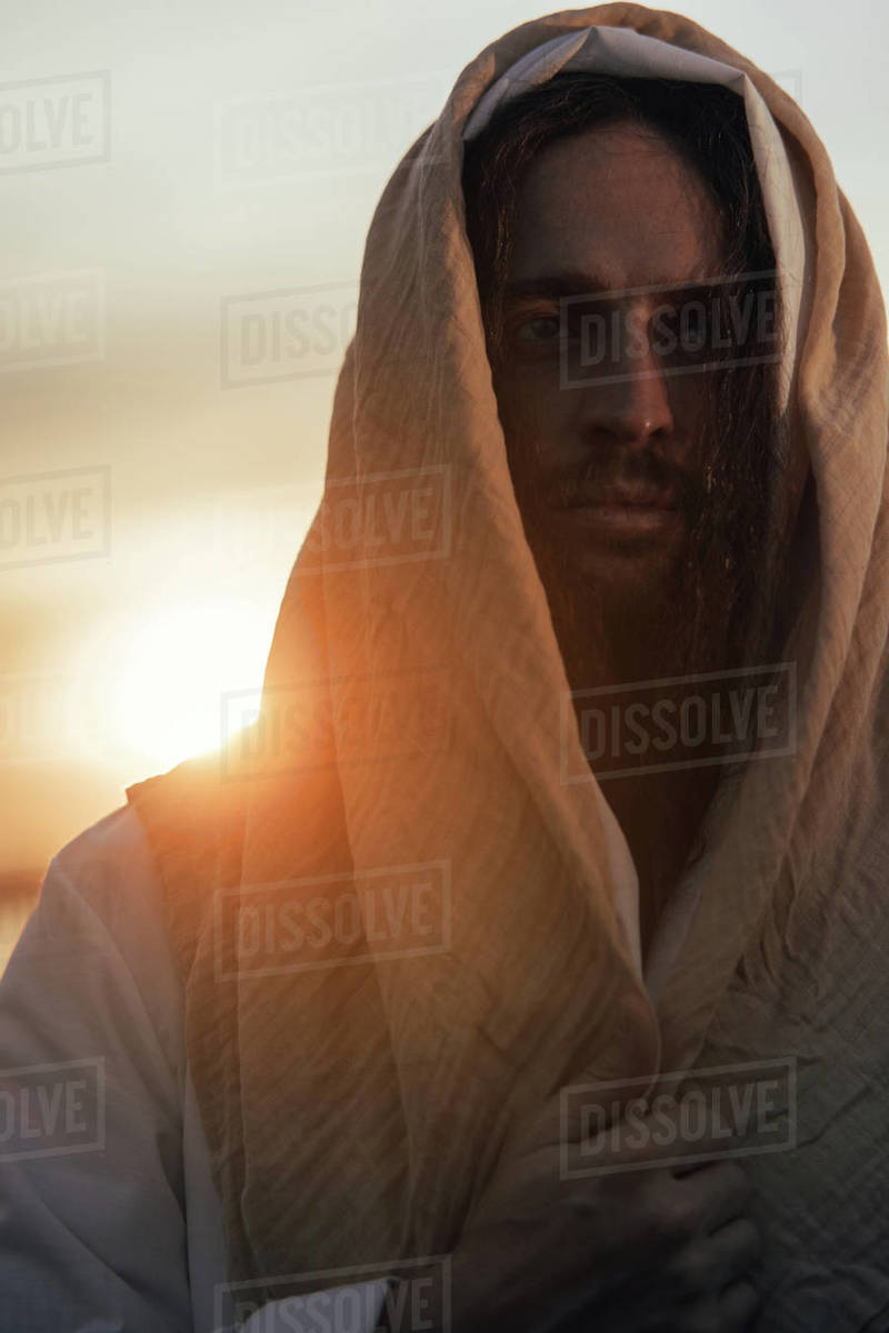 Prophet in his traditional white robe against sunset sky background ...