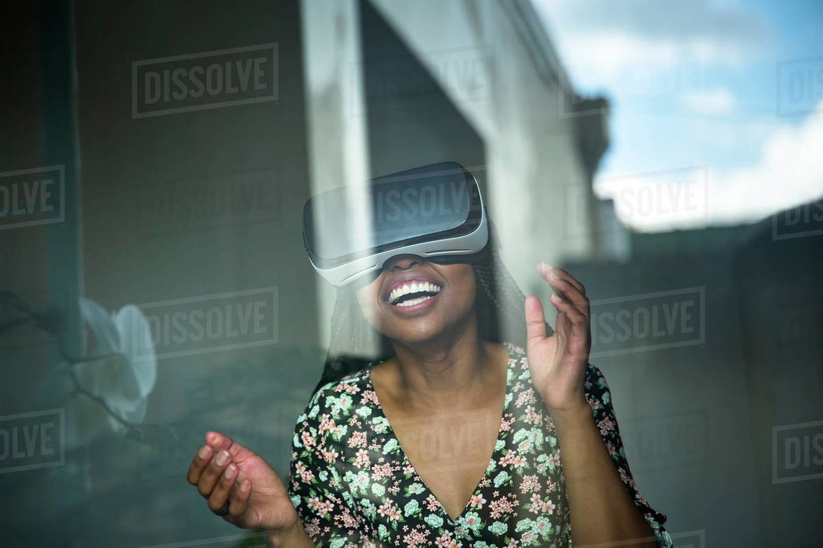 African woman looking through VR headset - Royalty-free Stock Photo ...