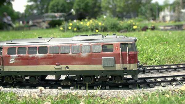 Red train. Model of red steam locomotive driving to its destination ...