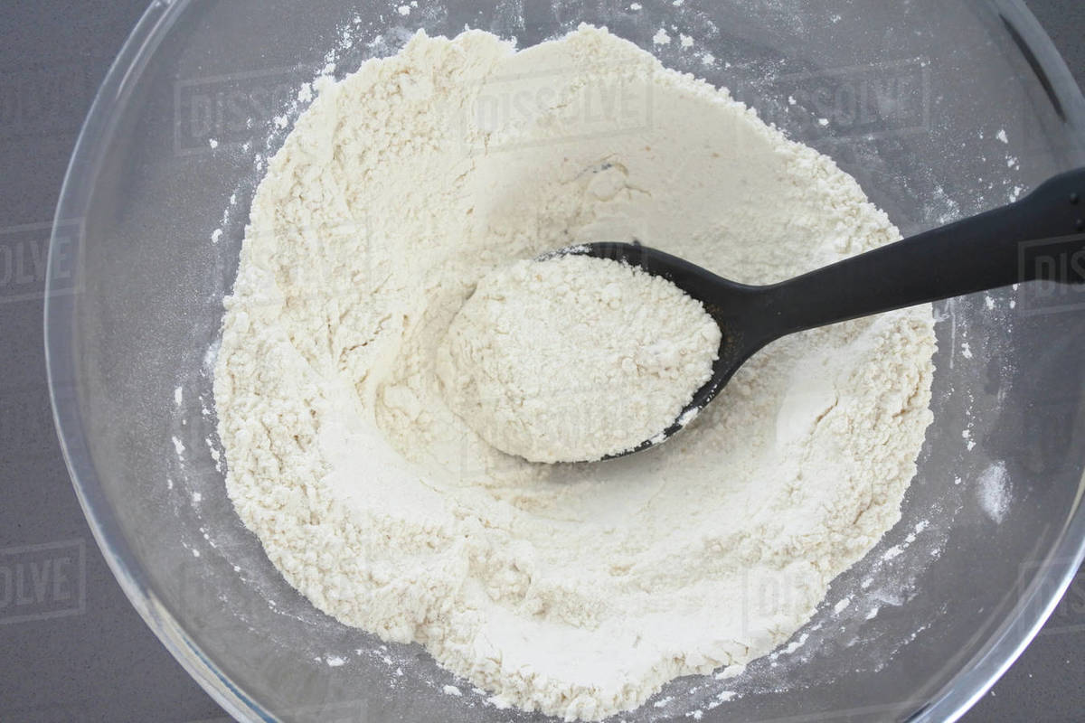Flat lay view of flour in a bowl on a kitchen top. - Stock Photo - Dissolve