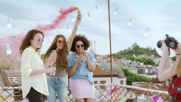 Group Of Diverse Teen Girls On Rooftop Smiling And Posing Holding Smoke ...
