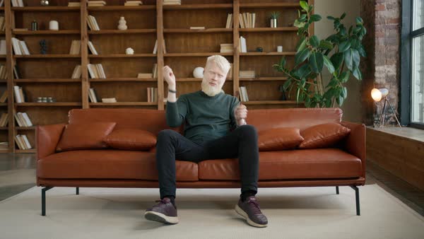 Excited drummer musician training at home, Albino guy playing invisible ...