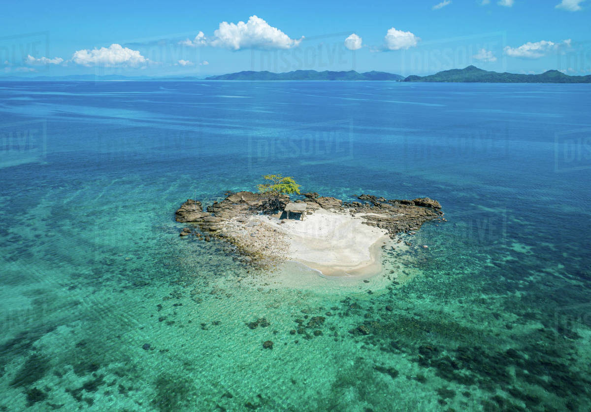 Aerial view of a small tropical island on an atoll with beautiful sandy ...