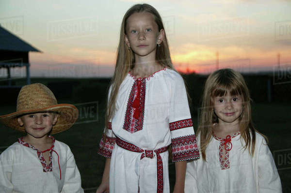 Slavic children in embroidered shirts on a sunset background. Children ...