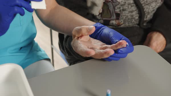 Processing a finger with a disinfectant wipe. Taking a blood test for ...