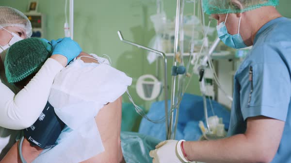 Male doctor injecting Epidural Anesthesia for pregnancy Labor during ...