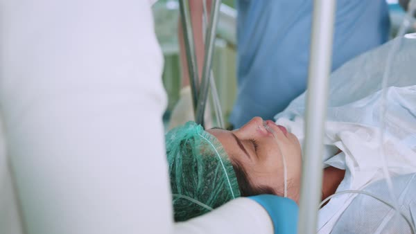 Close up of patient during surgery. Woman lies on table under ...