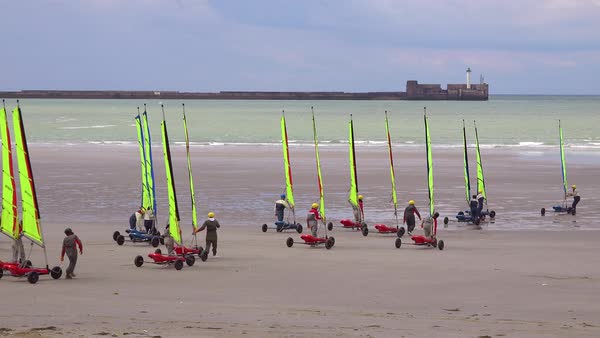 Land carts or sail carts or blokarts are wheeled onto the beach in ...