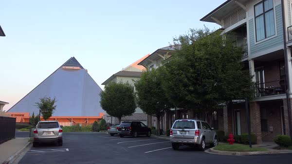 Establishing shot of an apartment complex with Memphis pyramid ...