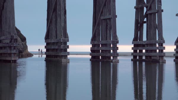 A historic wooden train tressel spans the beach where Pudding Creek ...