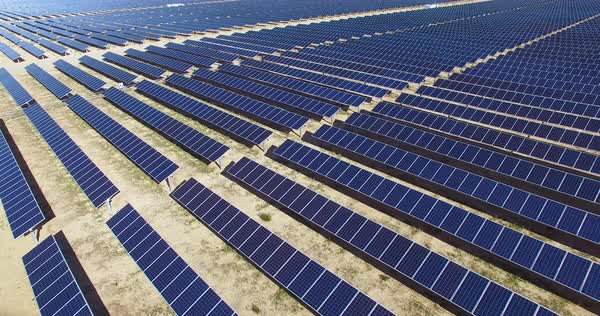 A beautiful aerial over a solar power farm in the Mojave Desert of ...