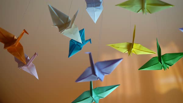 Many origami birds waving in wind on sunny background, Japanese ...