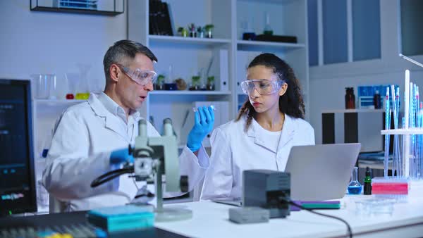 Scientists checking cultured meat sample in food quality control ...