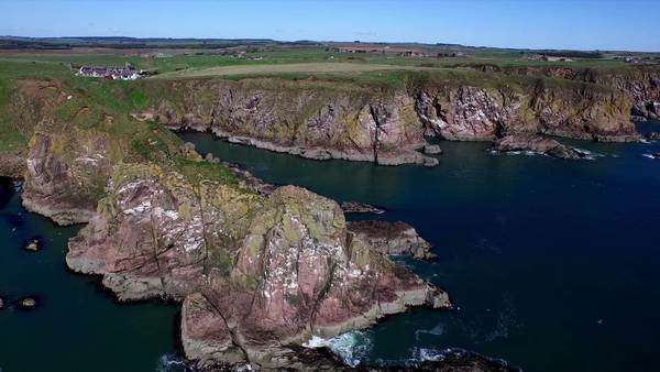 Aerial shot of sea cliffs off the coast of Scotland near Aberdeen ...