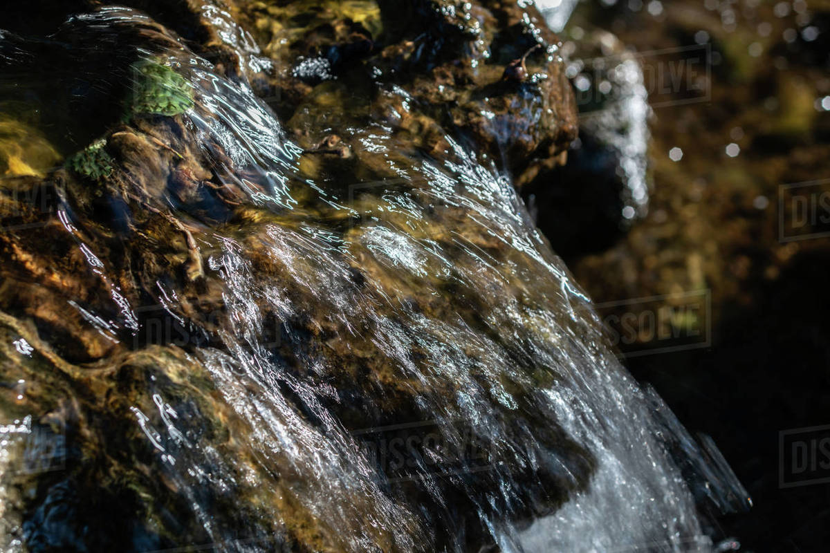 Water Rushing over rocks in a stream - Stock Photo - Dissolve