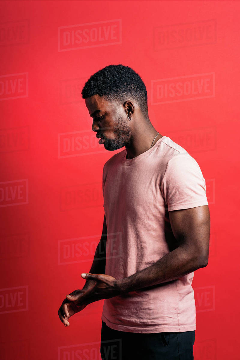 Portrait of young african man on bright red background - Royalty-free ...