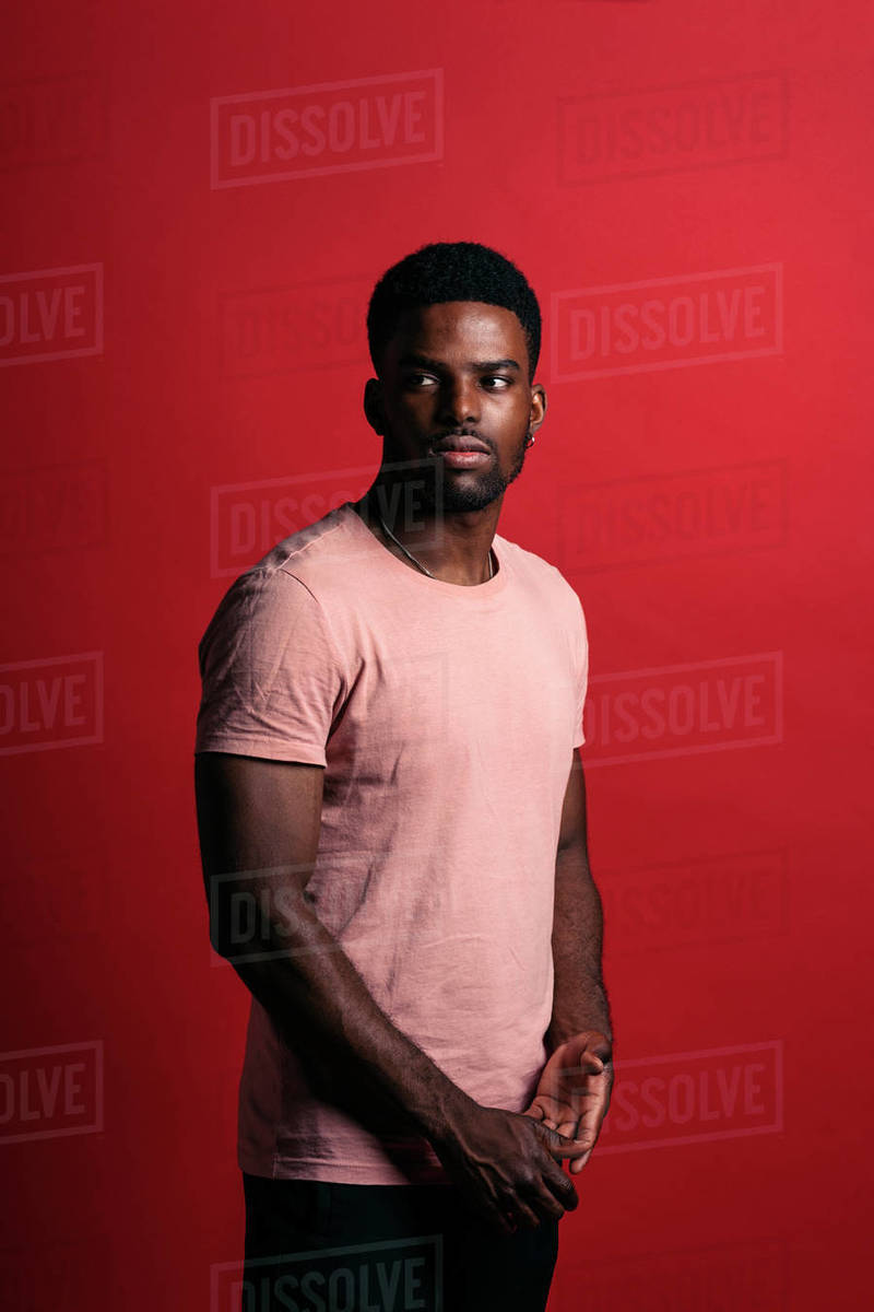 Portrait of young african man on bright red background - Stock Photo ...