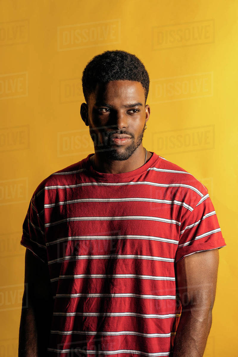 Portrait of young african man on bright yellow background - Stock Photo ...