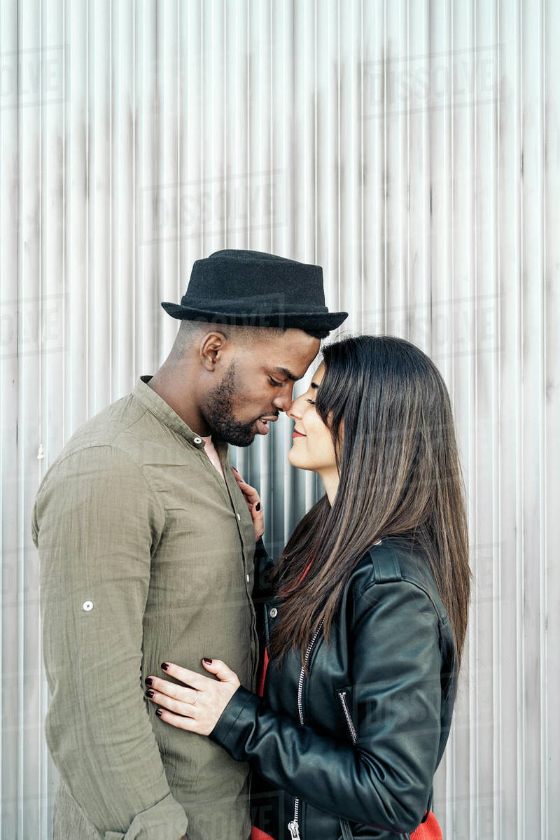 Young couple having romantic moments together in the street ...