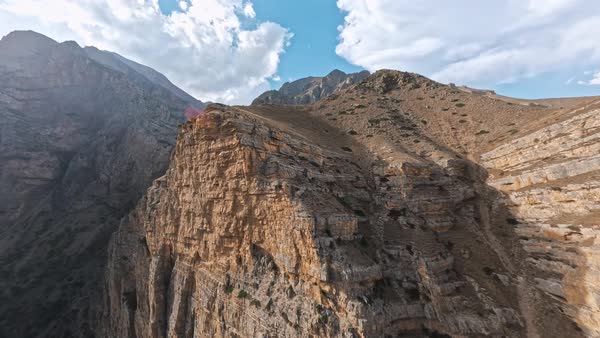 FPV rotation dynamic dive from mountain rock geology formation stone ...