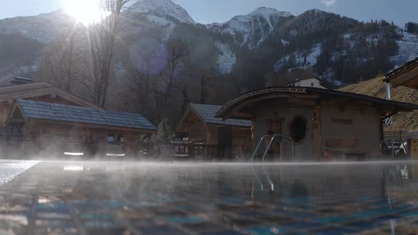 Hot swimming pool water surface steam vapor wooden bathhouse spa resort ...