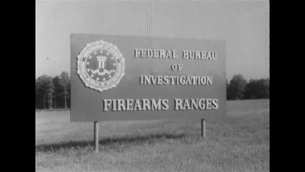1960s - A policeman demonstrates some gun safety tips at a firing range ...