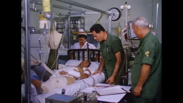 1968 - Army medics attend to a badly injured patient in a Vietnam field ...