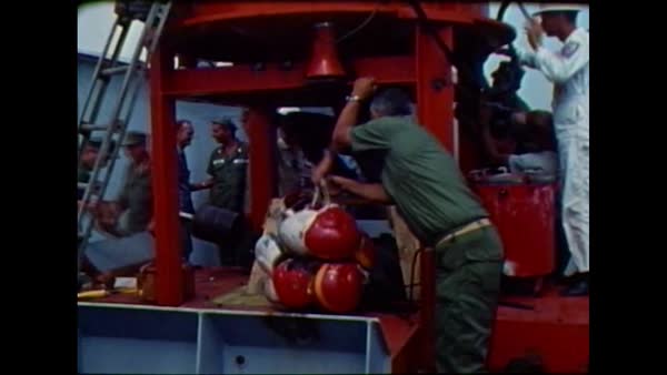 1966 - A Personnel Transfer Capsule is lowered from a United States ...