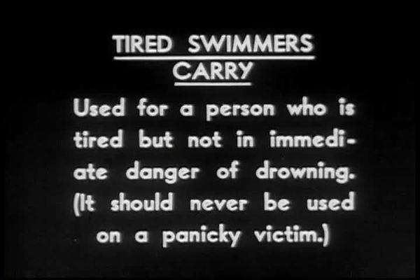 The correct way to assist a tired swimmer in 1933, demonstrated and ...