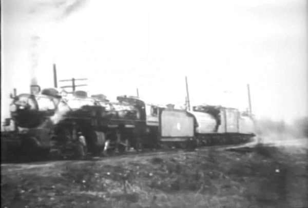 A steam engine loses to an electric train in a tug-of-war in the 1920s ...