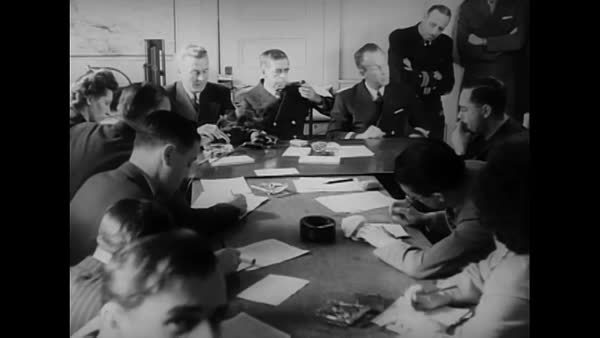 1945 - Reporters are crowded around a table to interview three US Army ...