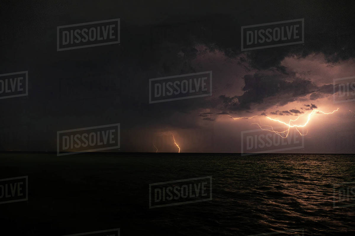 Lightning over water. Electric discharge. Nature background for design ...