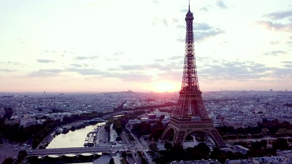 Elevated frone view of Eiffel tower with sun facing, tilting down to ...
