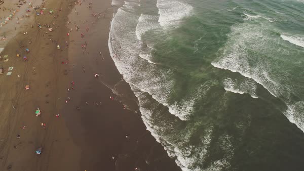 sandy beach parangtritis near ocean with big waves, people in tropical ...