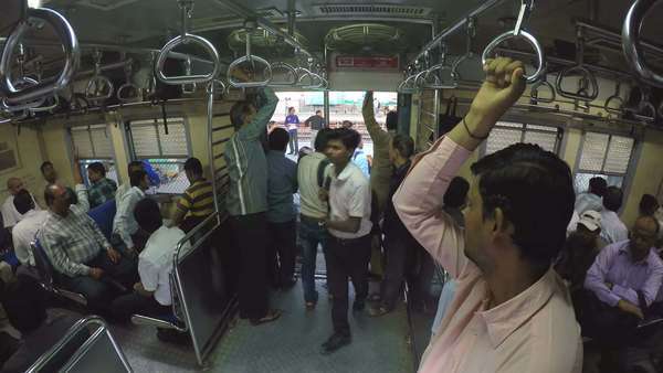 MUMBAI, INDIA - 7 JANUARY 2015: Indian men entering the train vagon ...