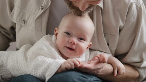 Caucasian bearded man father daddy tickling baby head with beard ...