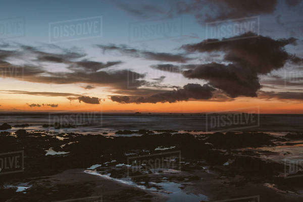 Dark clouds at sunset over ocean - Royalty-free Stock Photo | Dissolve