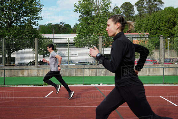 two young adult athletes competing against each other to win a friendly ...
