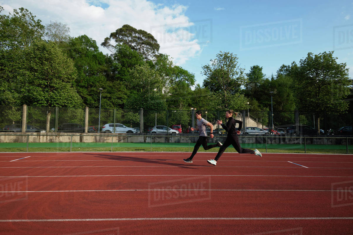 two young adult athletes competing against each other to win a friendly ...