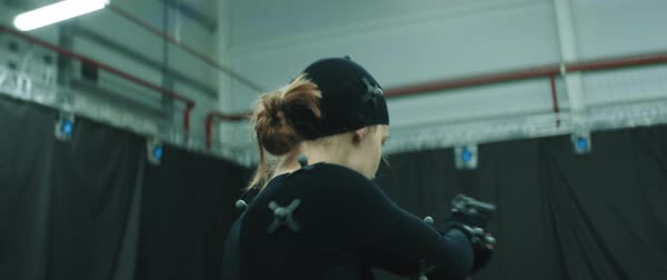 Female actor wearing motion capture suit acting as a game or animation ...