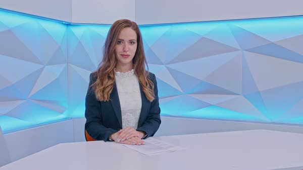 Female TV presenter looking at the camera and smiling - Stock Video ...