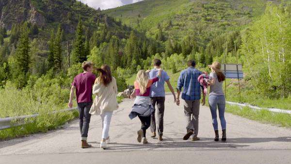 Three teenage girls hop on their boyfriend's backs for piggyback rides ...