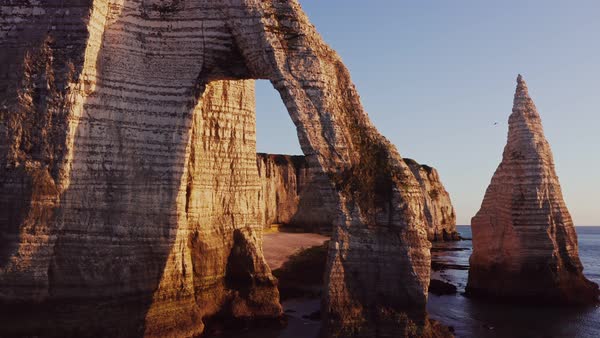 Beautiful coastal cliffs of bizarre shapes with natural arches and wild ...