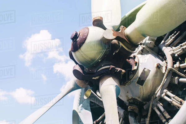 A close-up of an old aircraft engine showing rust and breakage. Visible ...