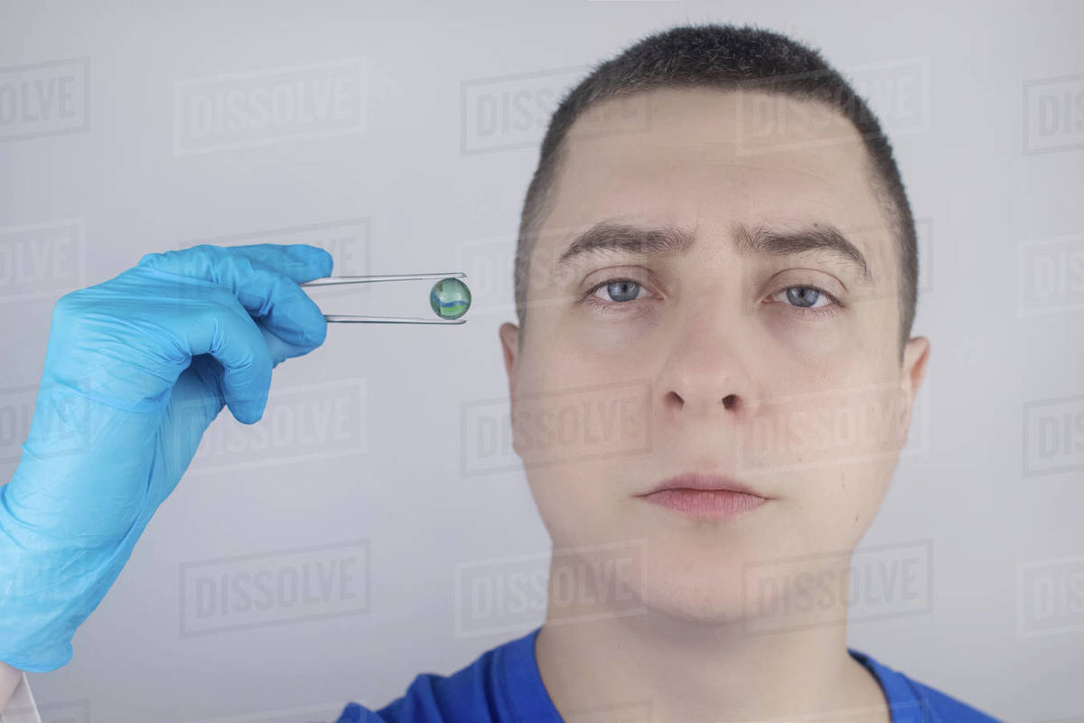 Conceptual shot of an eye crystalline lens replacement. Ophthalmic ...