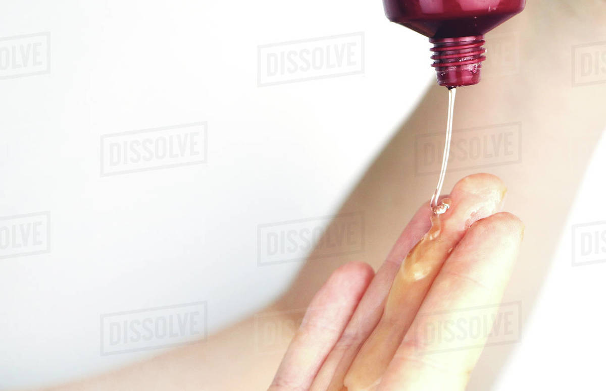 Fingers are squeezed out of the tube mask film for the face. Face care ...