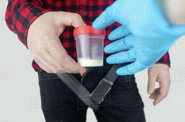 Man takes semen analysis. Spermogram. Concept. Male with his pants ...
